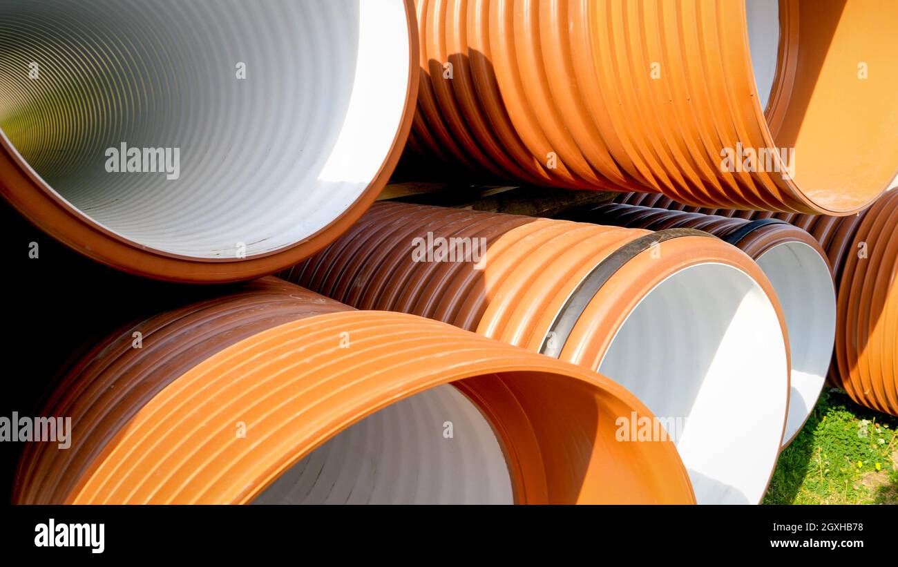 Closeup shot of new plastic pipes and tubes stacked on the building ...