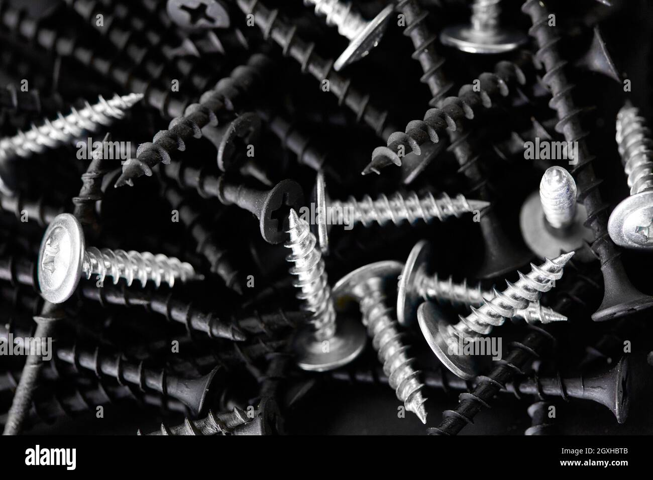 Stack of self-tapping screws, grey background, nobody. Professional ...