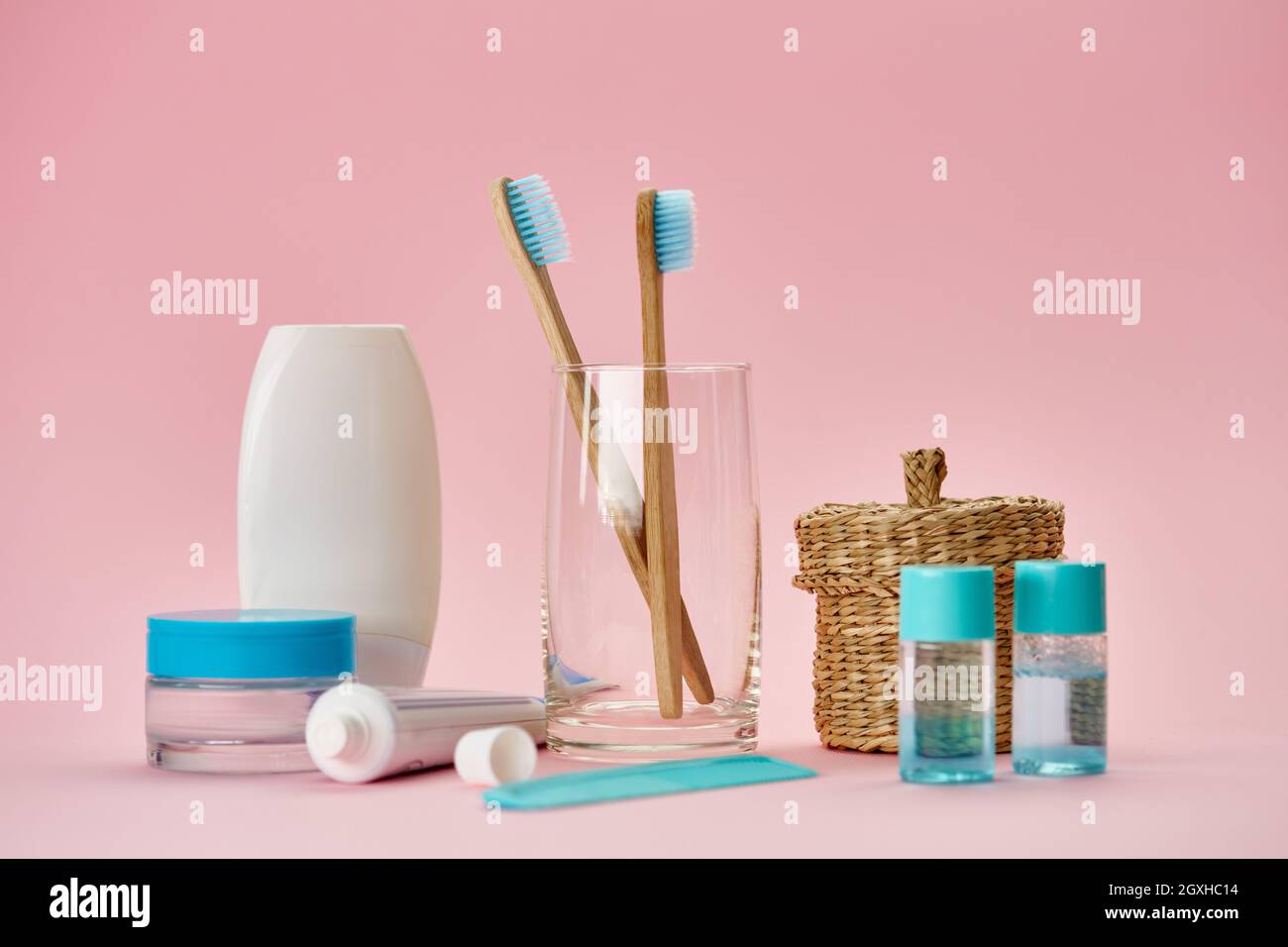 Oral care products, two toothbrush and toothpaste, macro view, pink ...