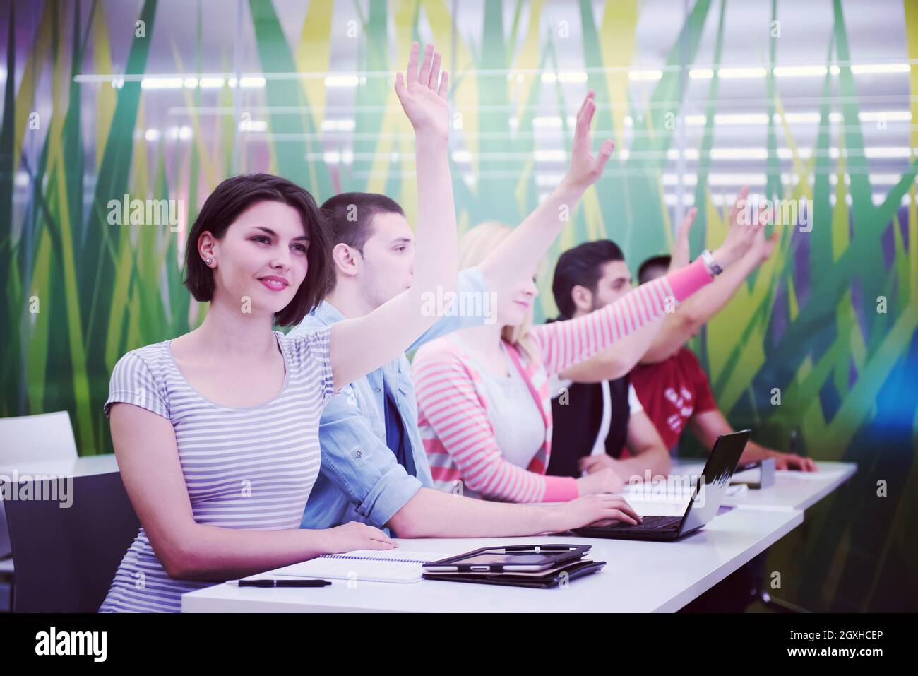 teacher teaching lessons, smart students group raise hands up in school ...