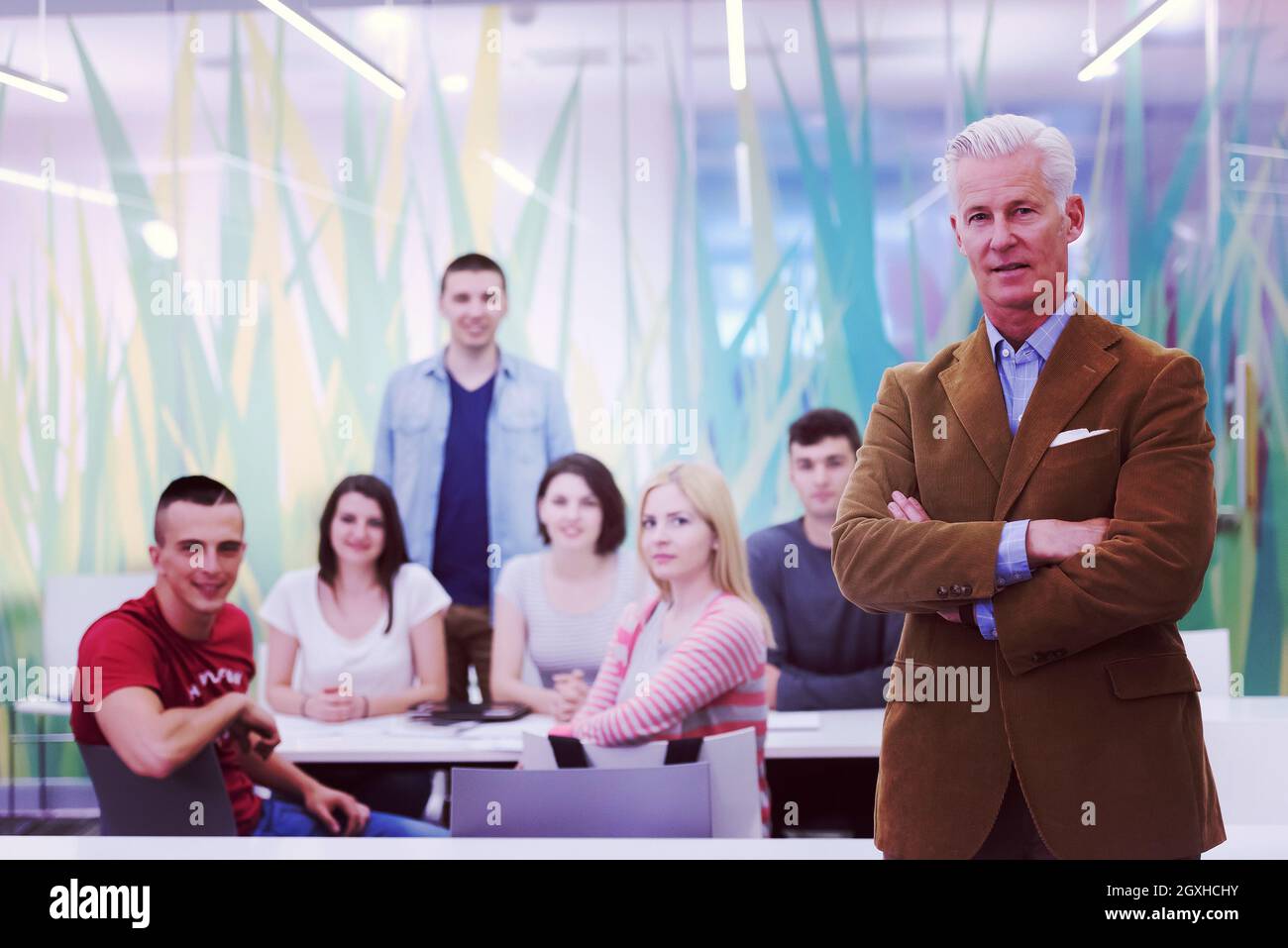 portrait of confident teacher, students group in background Stock Photo ...