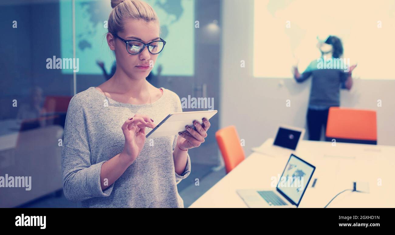 Businesswoman using tablet at the work in office Stock Photo - Alamy