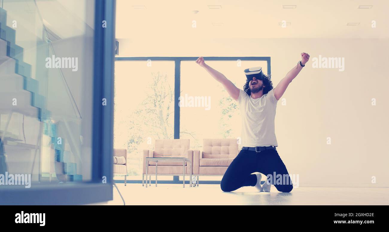 happy man getting experience using VR-headset glasses of virtual ...