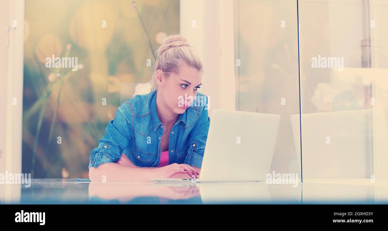 beautiful young women using laptop computer on the floor of her luxury ...