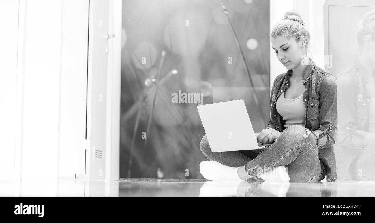 beautiful young women using laptop computer on the floor of her luxury ...