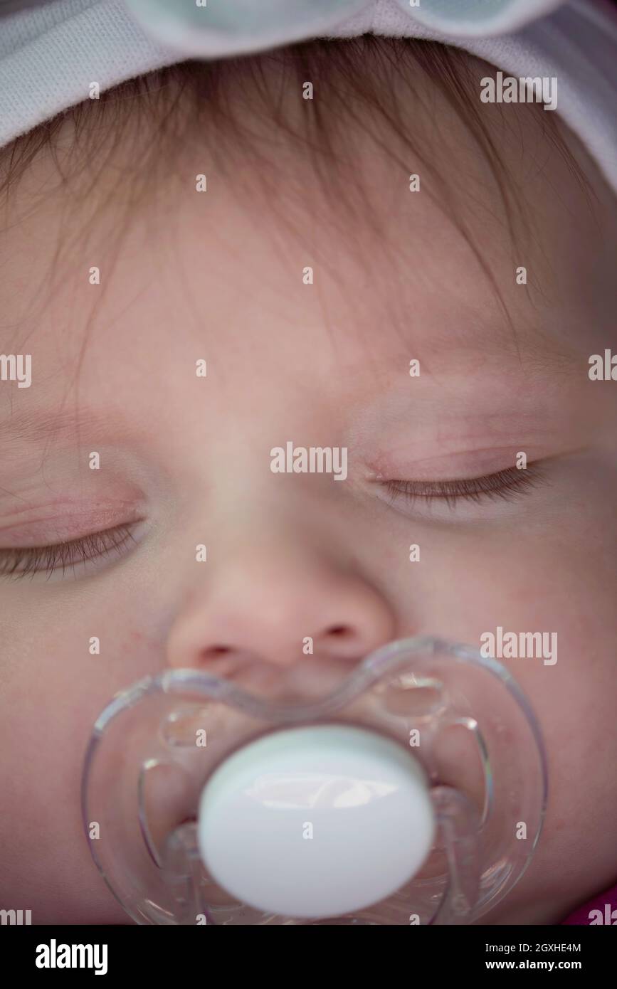 newborn baby girl sleeping in bed at home Stock Photo - Alamy