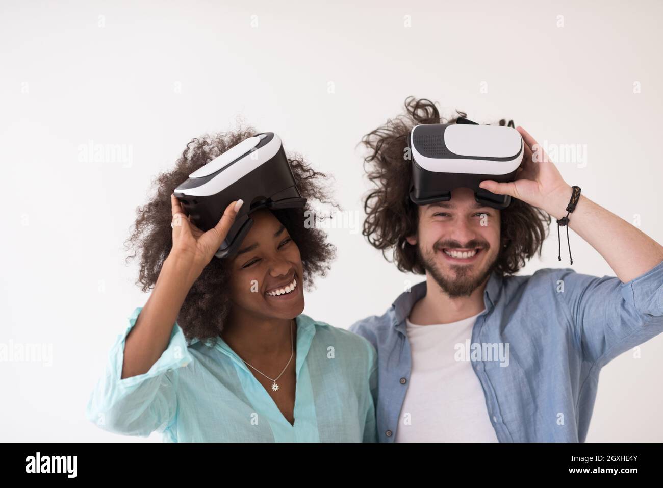 Happy multiethnic couple getting experience using VR headset glasses of ...