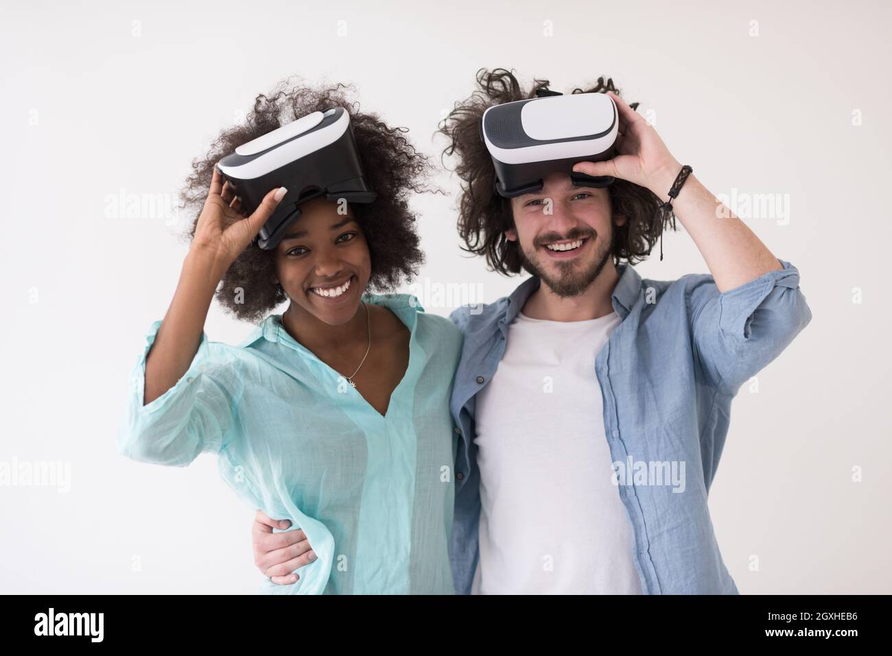 Happy multiethnic couple getting experience using VR headset glasses of ...