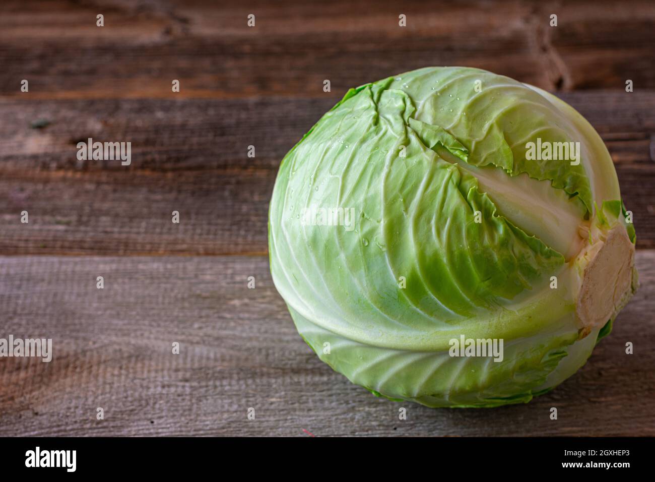 Whole cabbage isolated on wooden table. Closeup and side view Stock ...