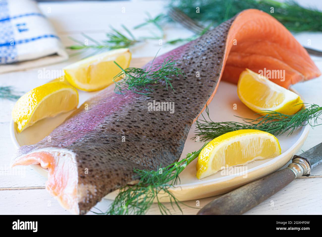 Raw and uncooked half salmon fillet on white background with lemon and ...