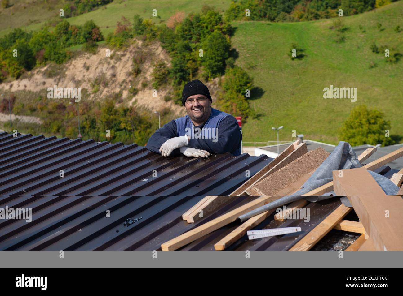 Construction workers working on new roof structure of building on ...
