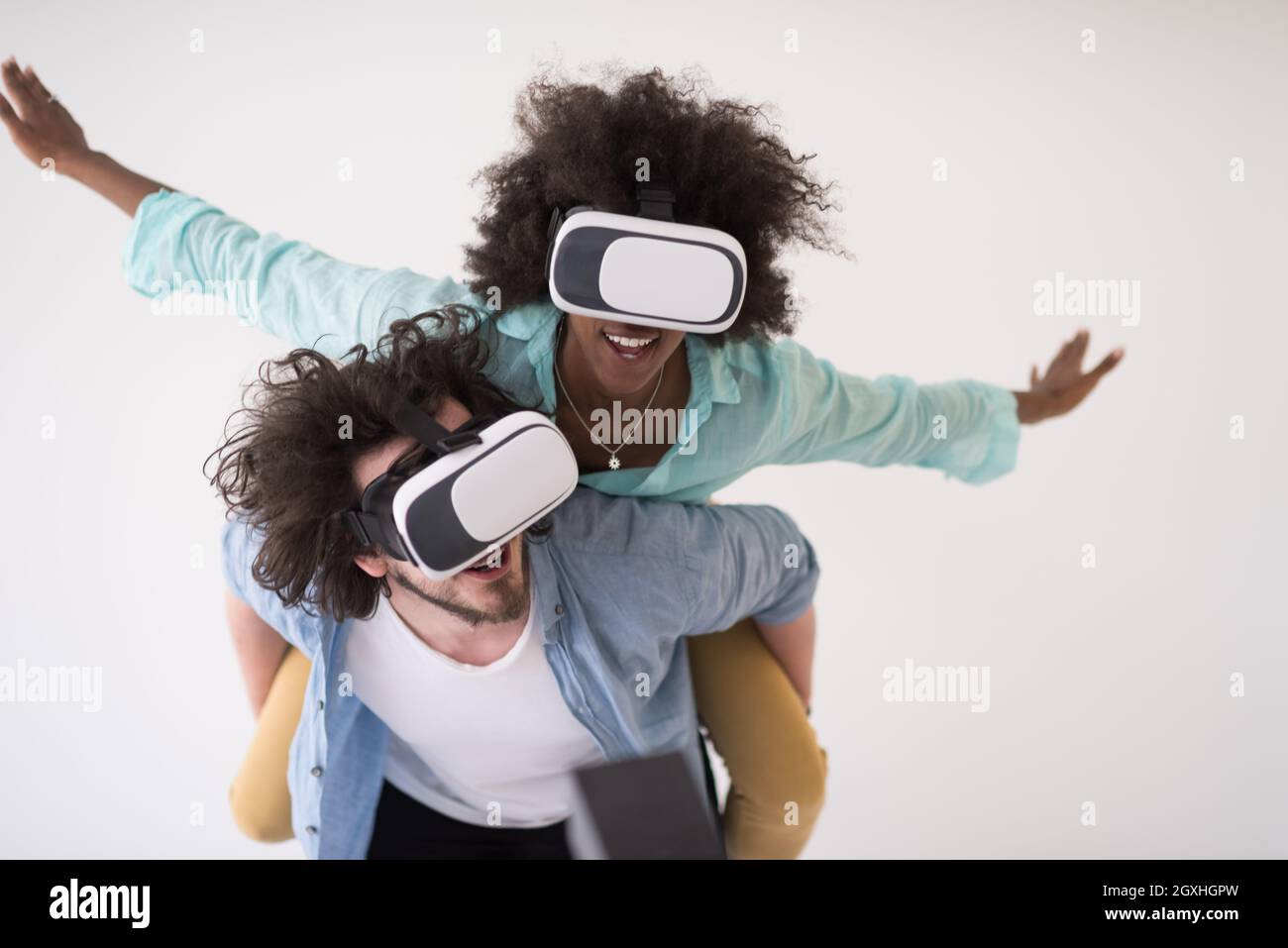 Happy multiethnic couple getting experience using VR headset glasses of ...