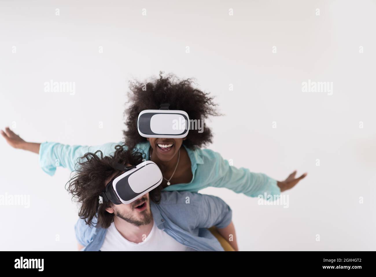 Happy multiethnic couple getting experience using VR headset glasses of ...