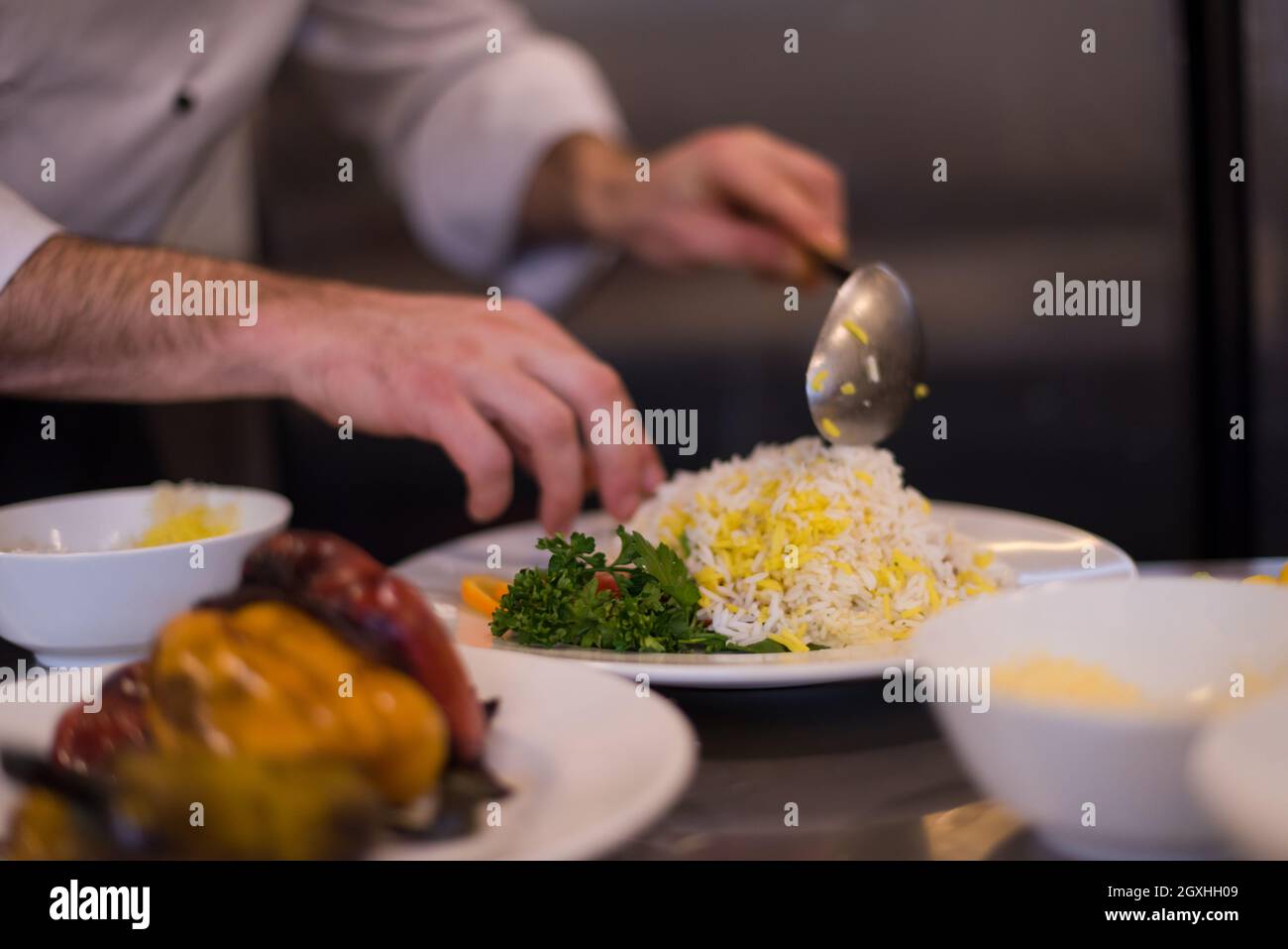 Chef hands serving vegetable risotto on restaurant kitchen Stock Photo ...