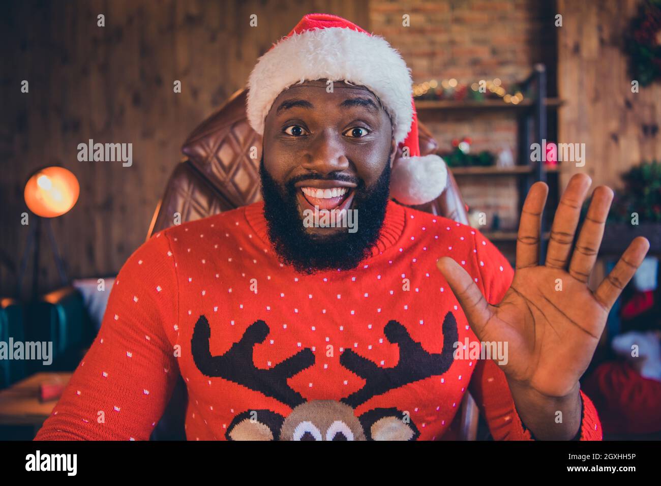 Portrait of attractive funny cheerful guy talking on web waving hi ...