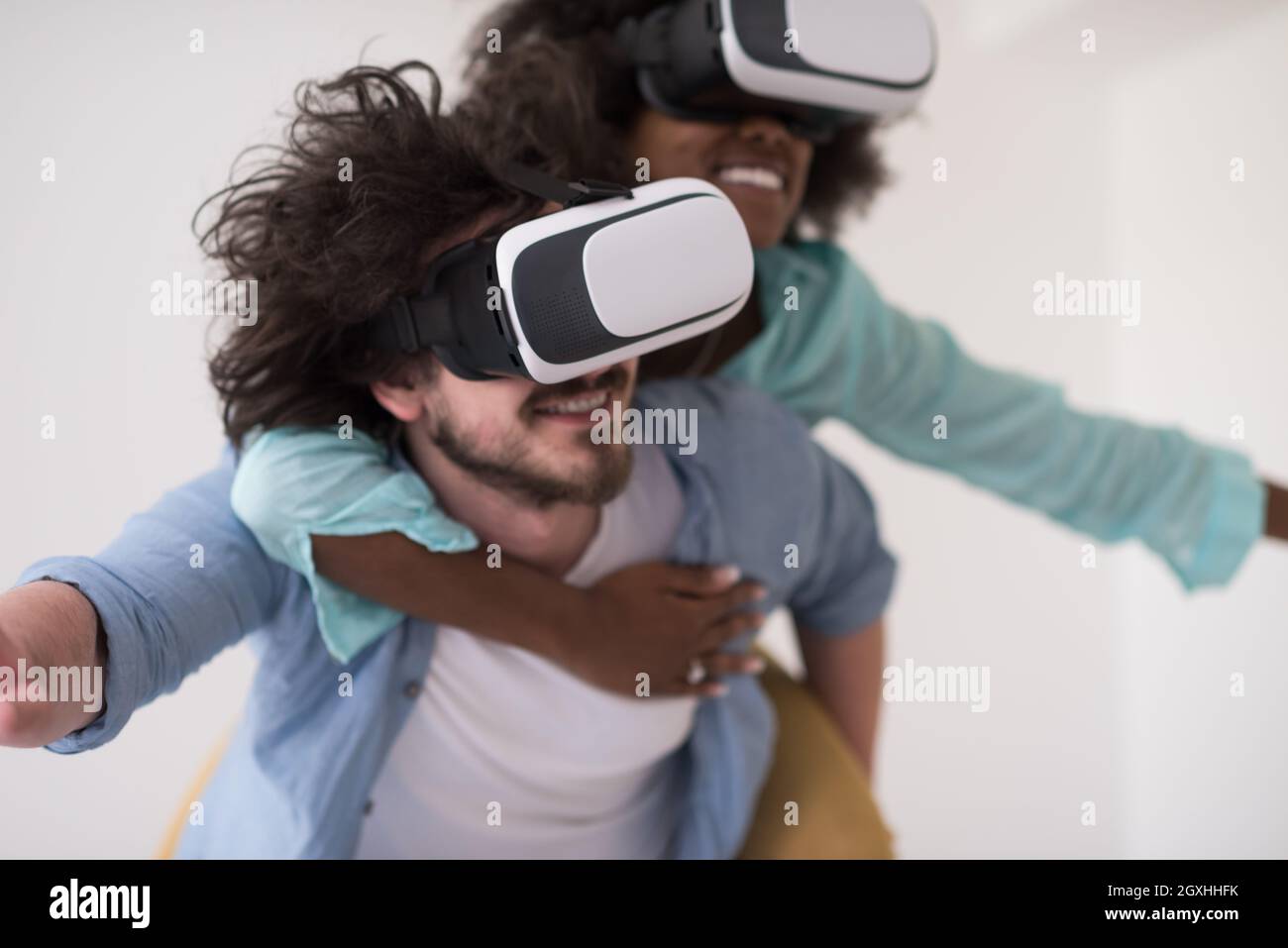 Happy multiethnic couple getting experience using VR headset glasses of ...