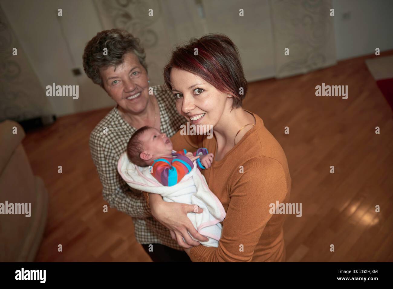 generations family portrait with grandparents parents and newborn baby ...