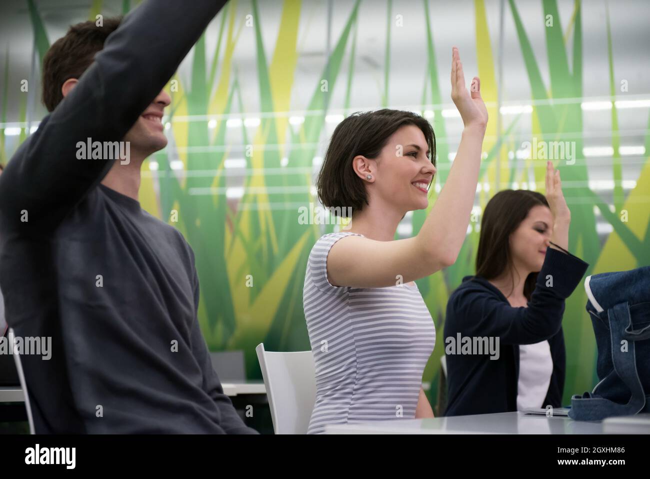 teacher teaching lessons, smart students group raise hands up in school ...