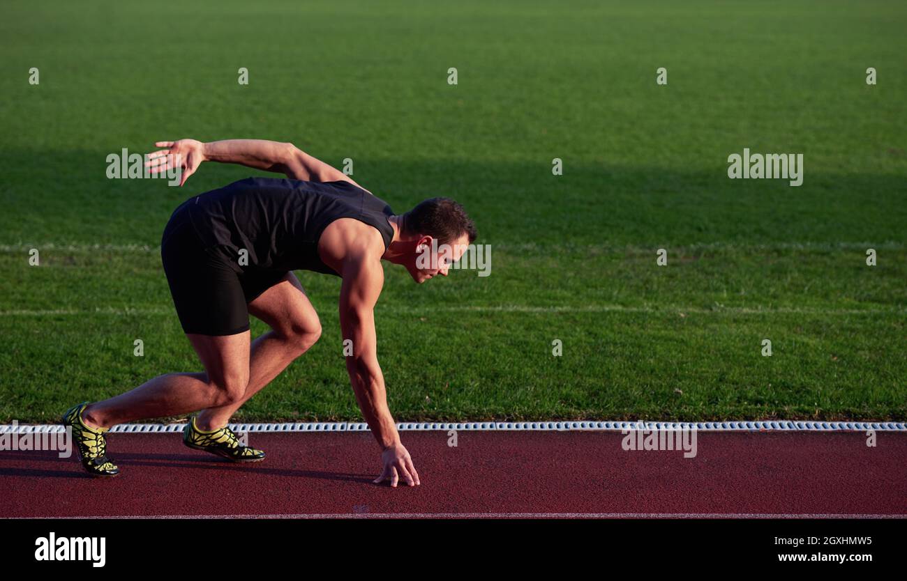 Sprinter leaving starting blocks on the running track. Explosive start ...