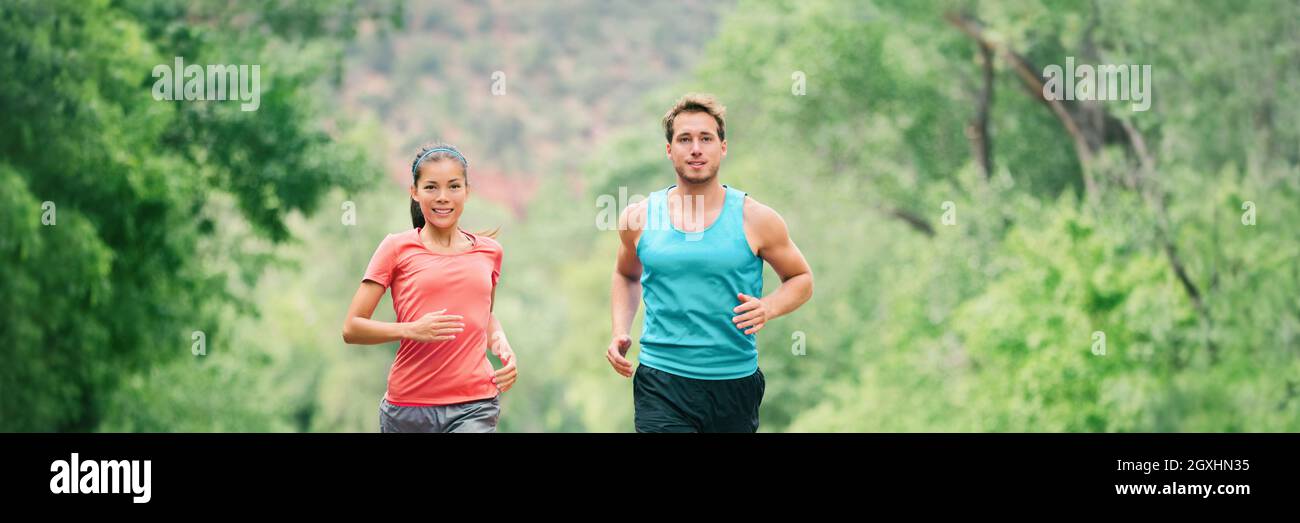 Running couple on trail run in forest park banner panoramic header. Fit ...