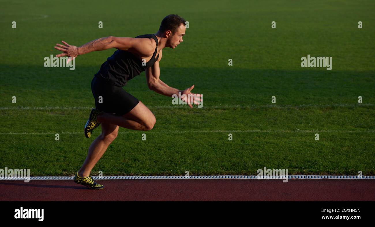 Sprinter leaving starting blocks on the running track. Explosive start ...