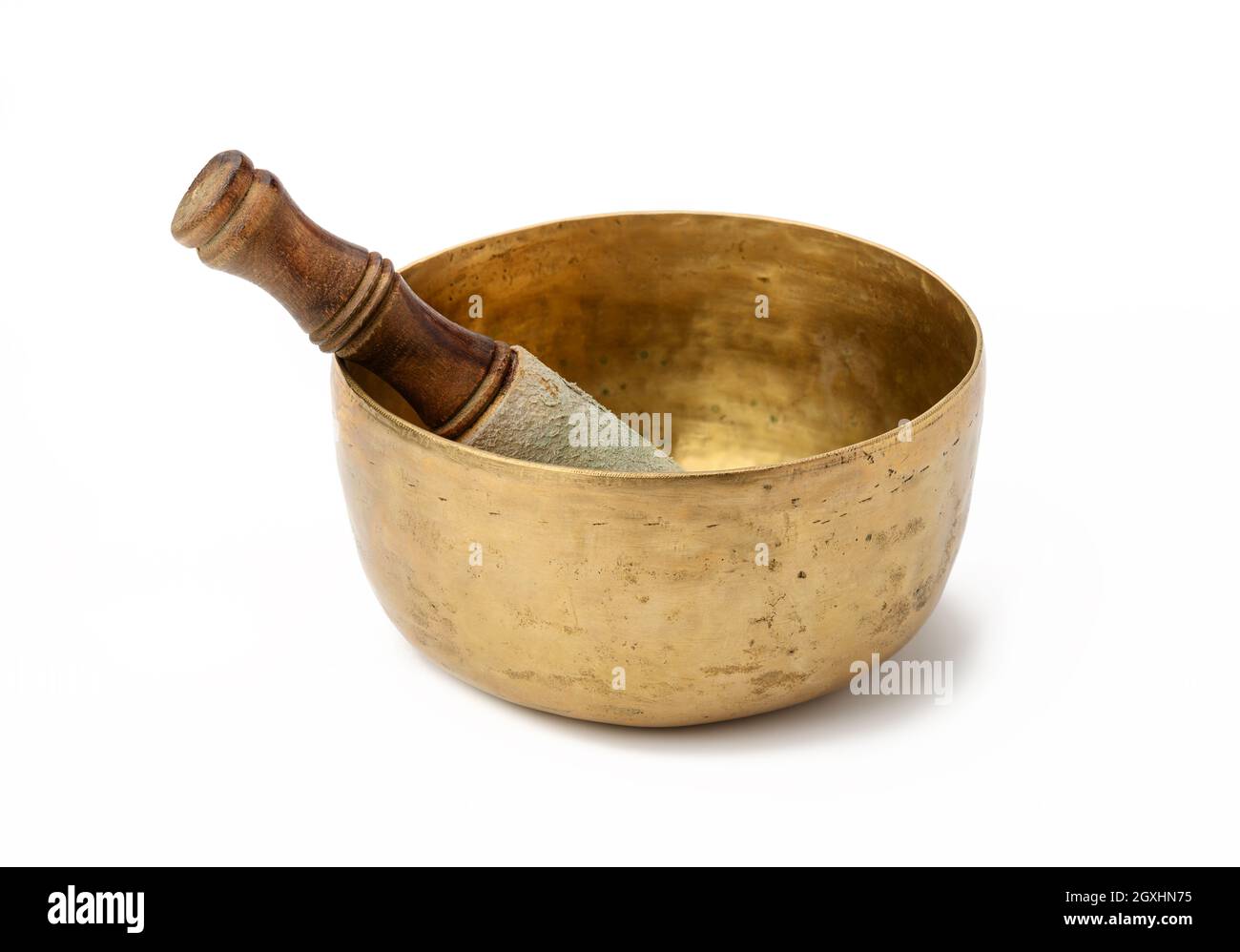 copper singing bowl and wooden clapper on a white background. Musical ...