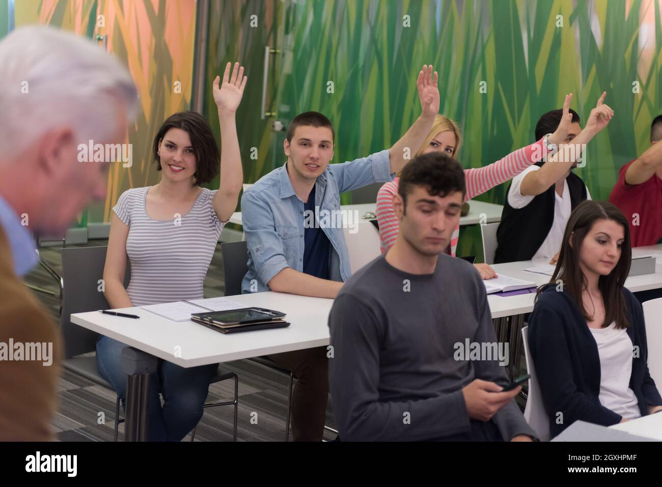 teacher teaching lessons, smart students group raise hands up in school ...
