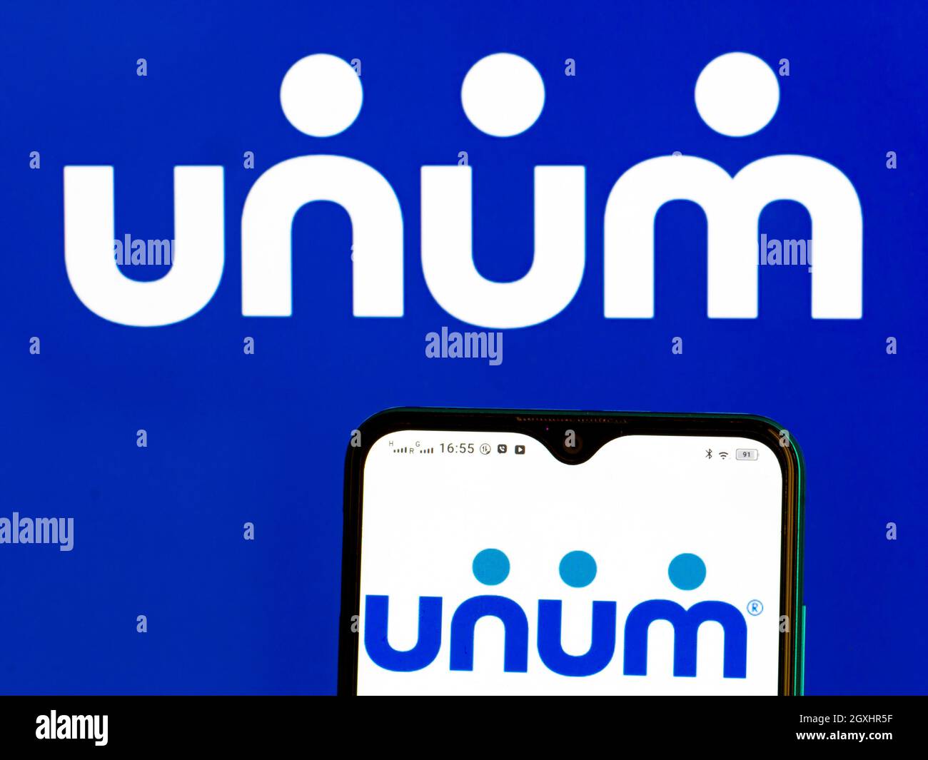 In this photo illustration Unum Group logo seen displayed on a ...