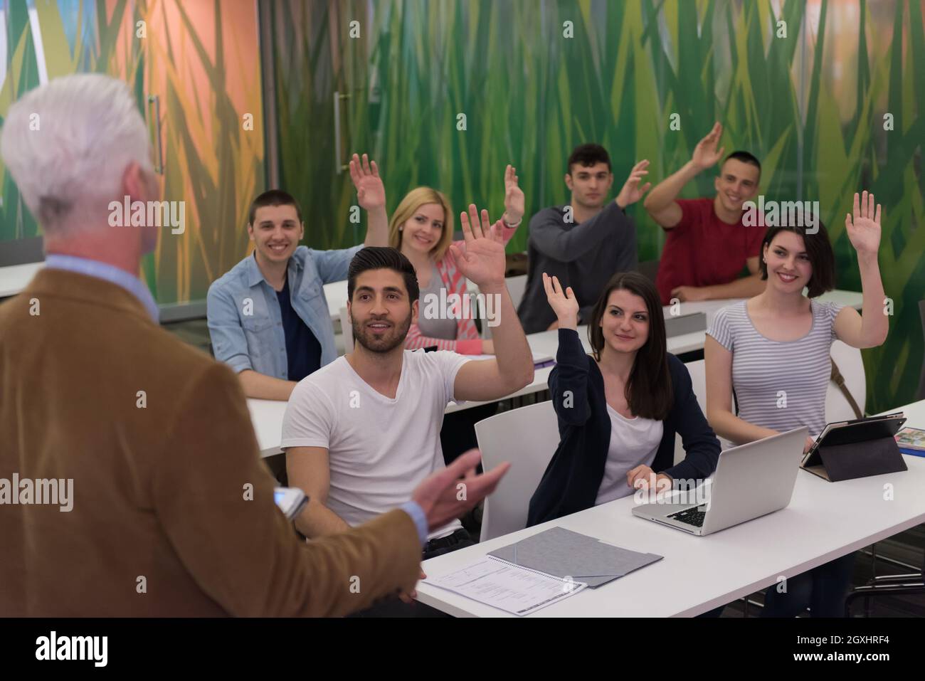 teacher teaching lessons, smart students group raise hands up in school ...