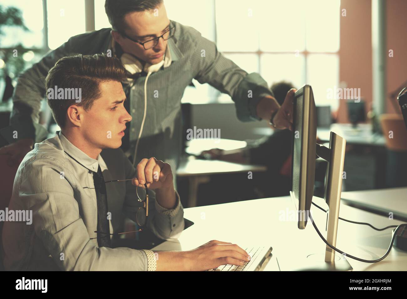 two business people using computer preparing for next meeting and ...