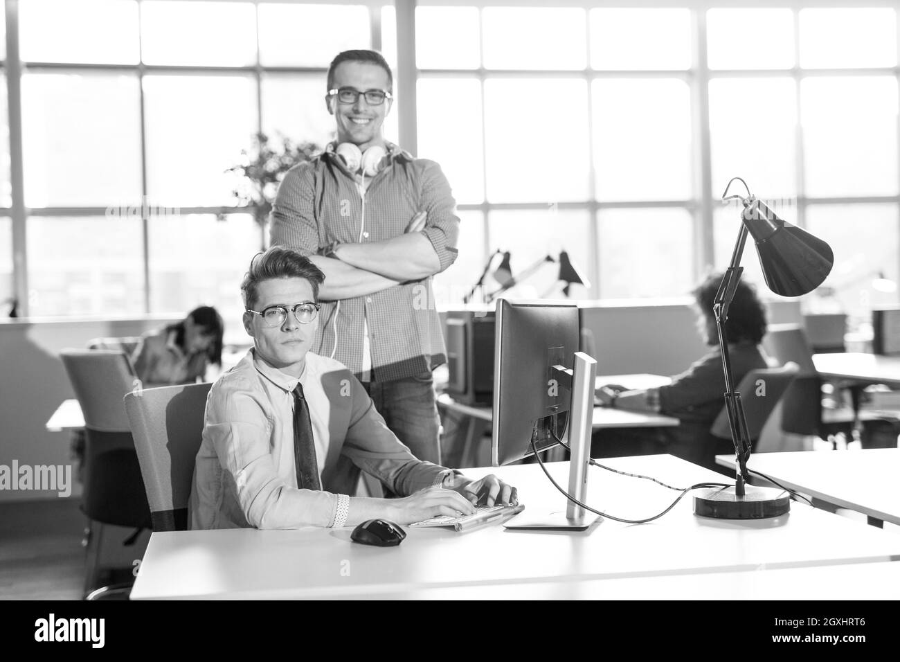 two business people using computer preparing for next meeting and ...