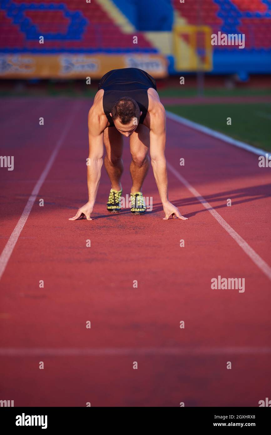 Sprinter leaving starting blocks on the running track. Explosive start ...