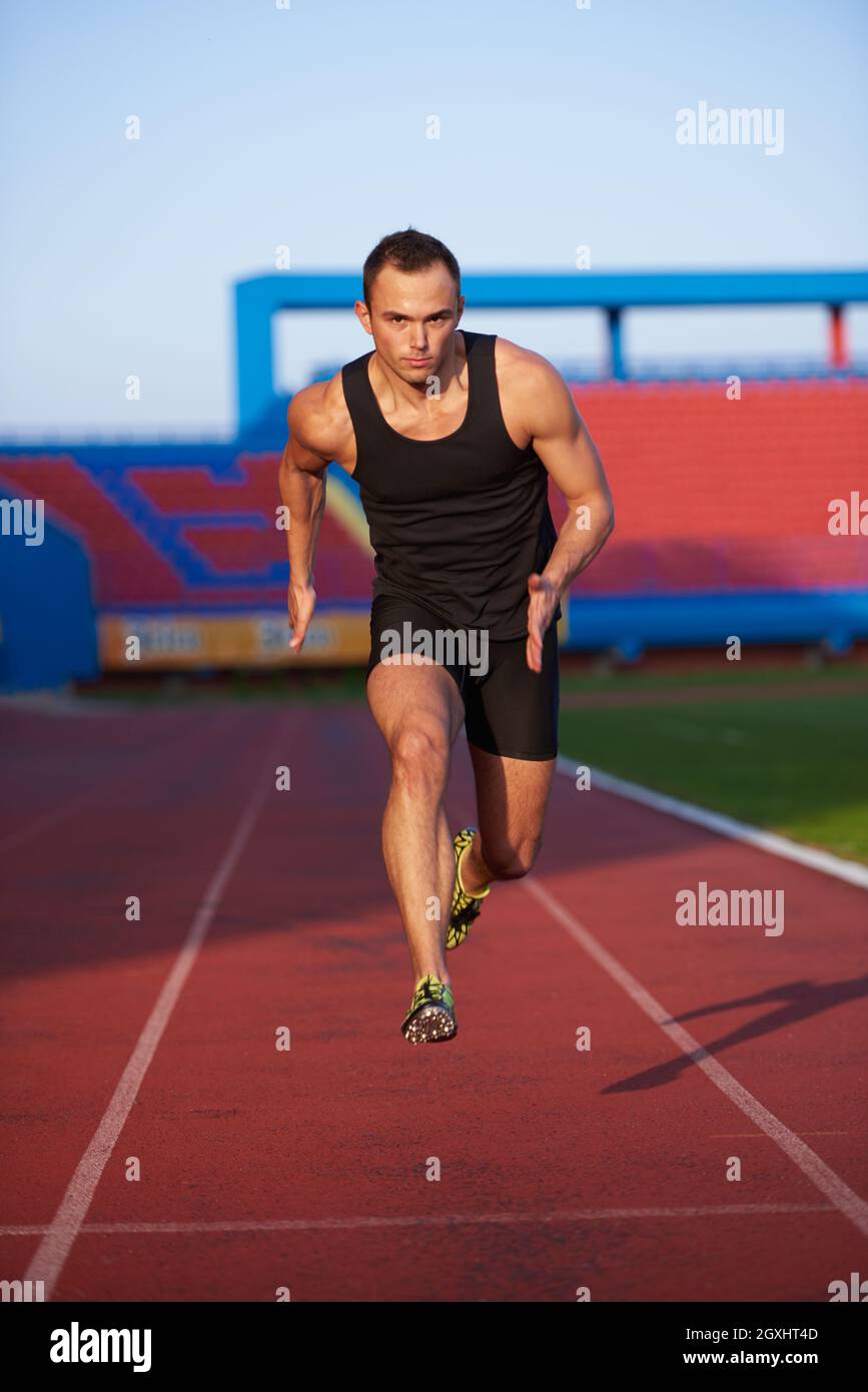 Sprinter leaving starting blocks on the running track. Explosive start ...