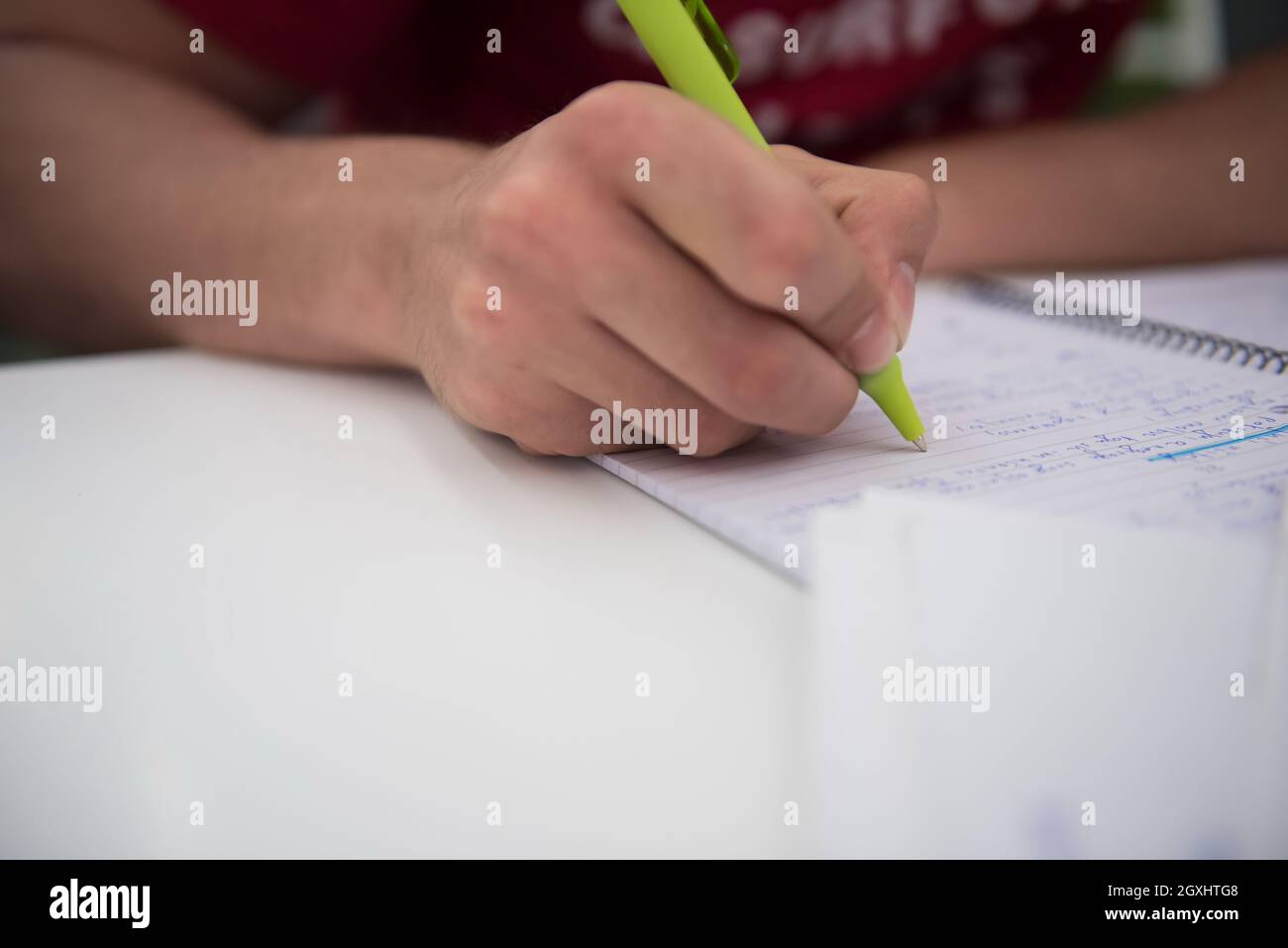 Close up of a student hand underlining a document on a desk at school ...