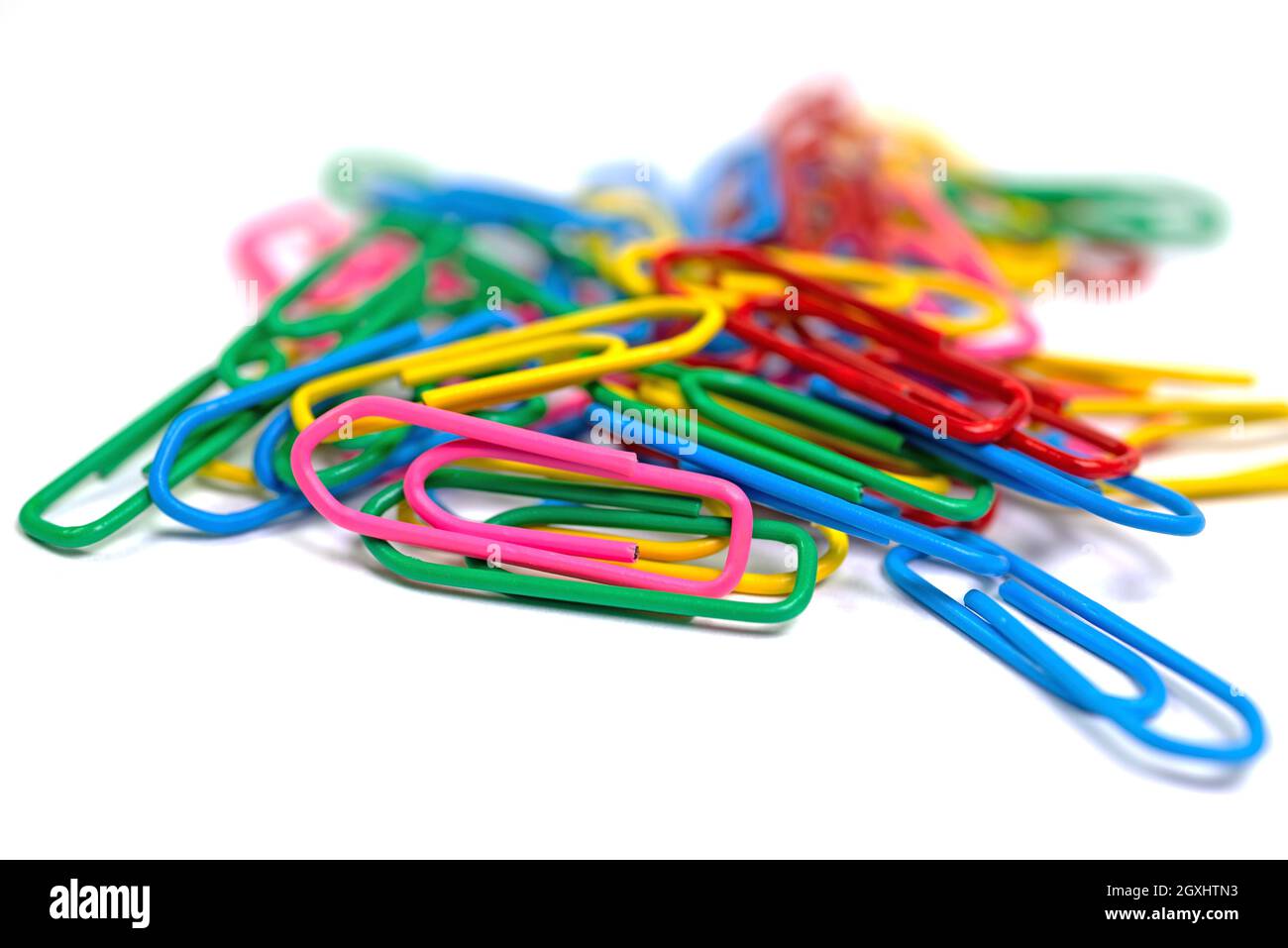 Lots of colorful paper clips against a white background Stock Photo - Alamy