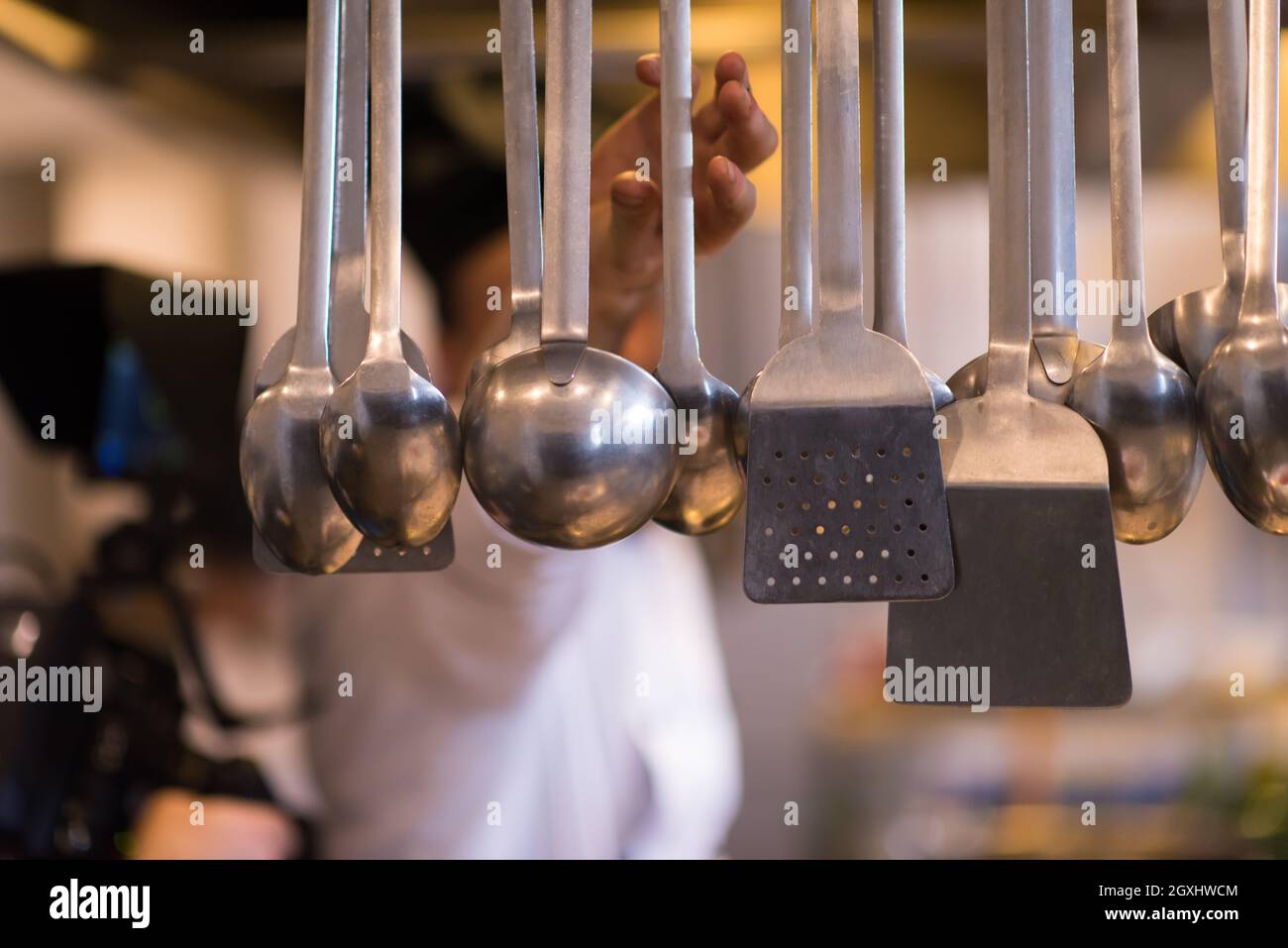 professional Cooking utensils hanging in a restaurant kitchen Stock ...