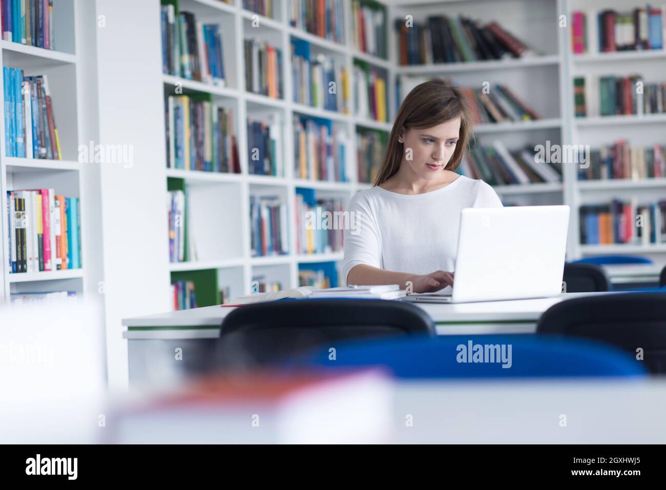 female student study in school library, using laptop and searching for ...