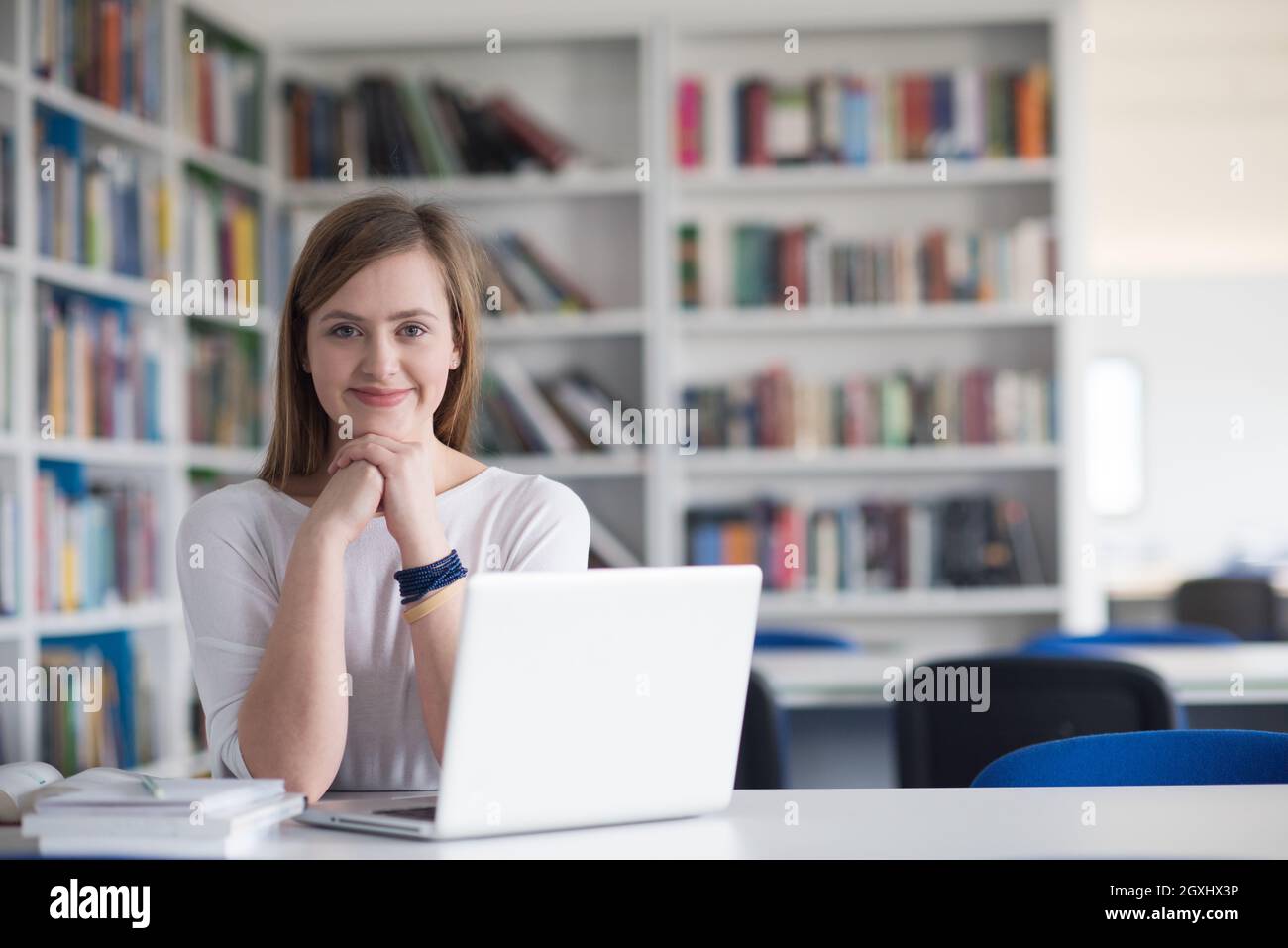 female student study in school library, using laptop and searching for ...