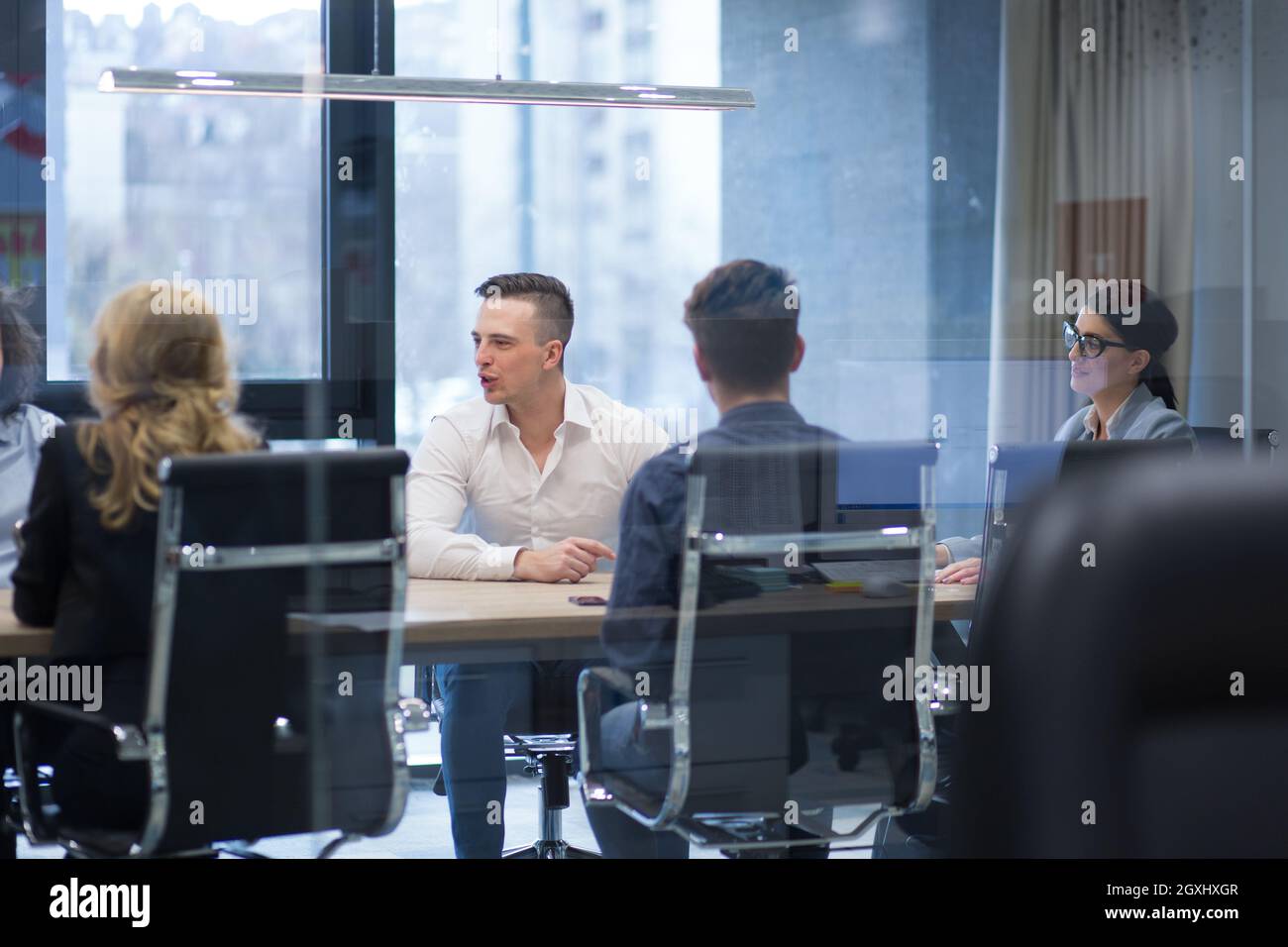 Group of a young business people discussing business plan at modern ...