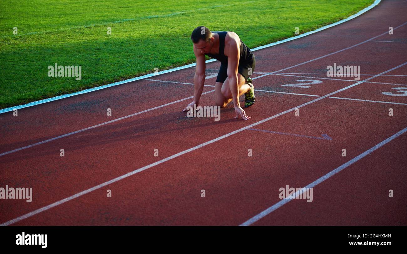 Sprinter leaving starting blocks on the running track. Explosive start ...
