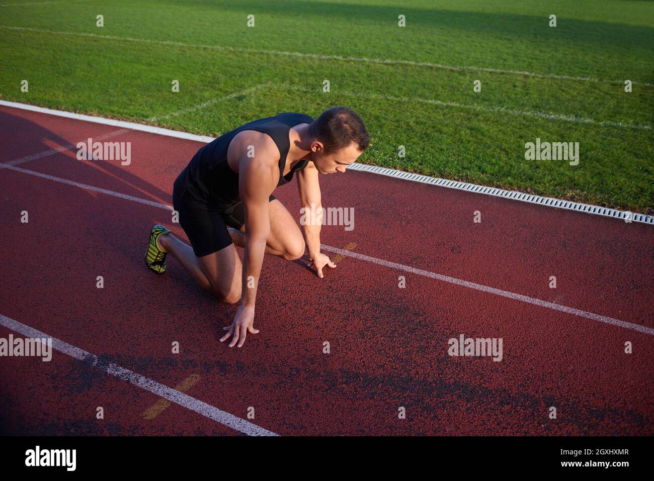 Sprinter leaving starting blocks on the running track. Explosive start ...