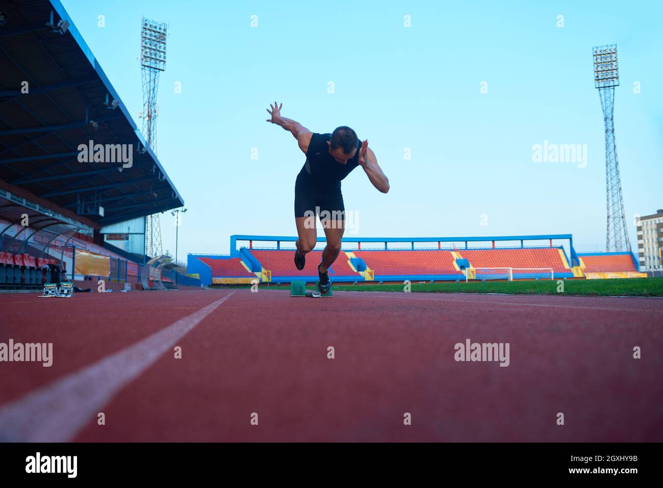 Sprinter leaving starting blocks on the running track. Explosive start ...