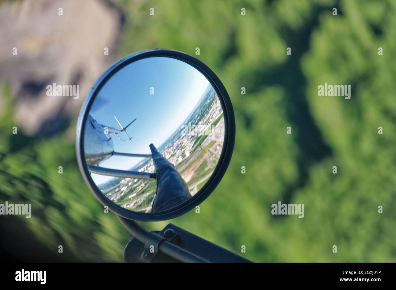 Mid-flight view of the mirror installed on the skid of a helicopter ...