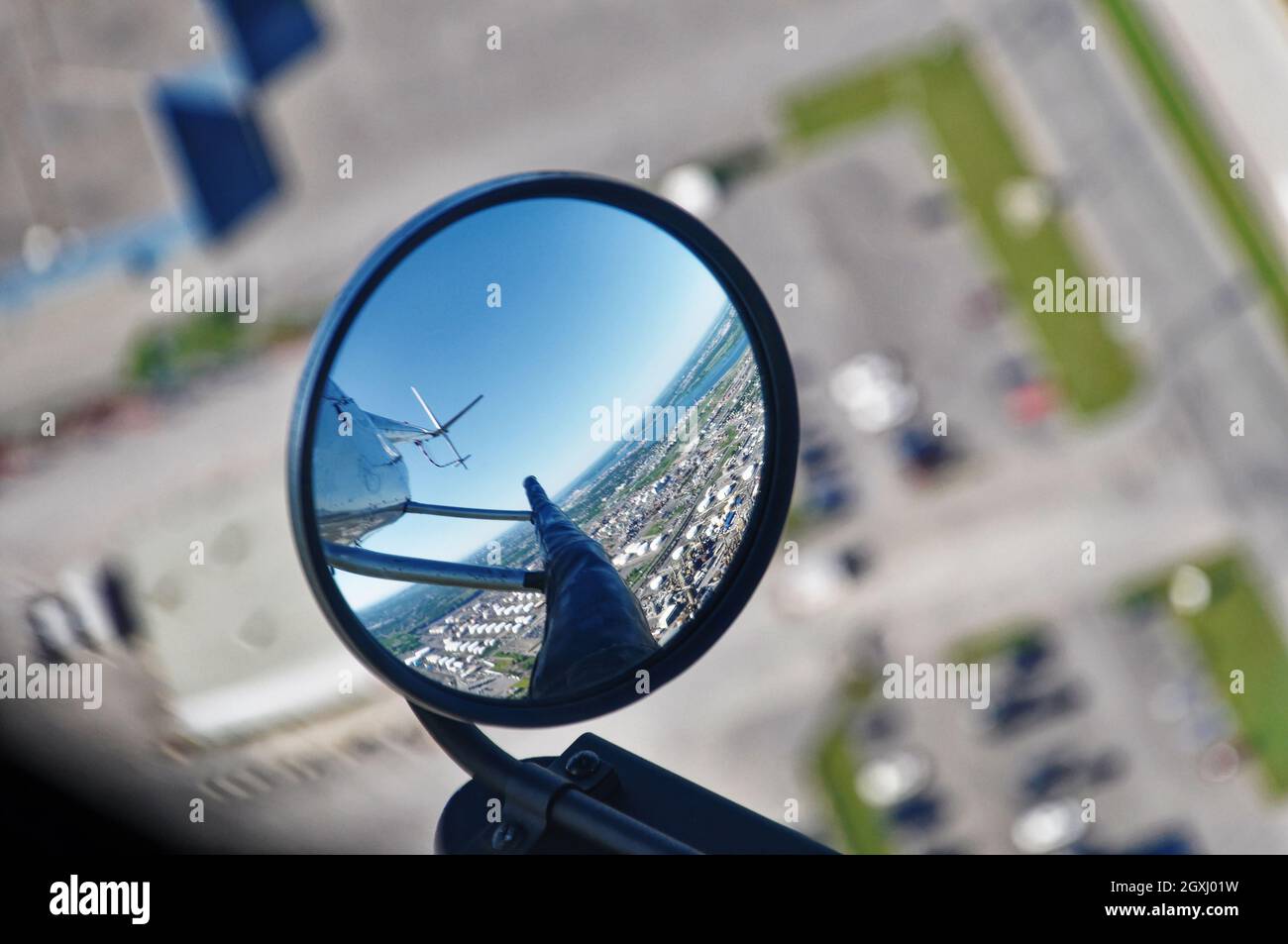 Mid-flight view of the mirror installed on the skid of a helicopter ...