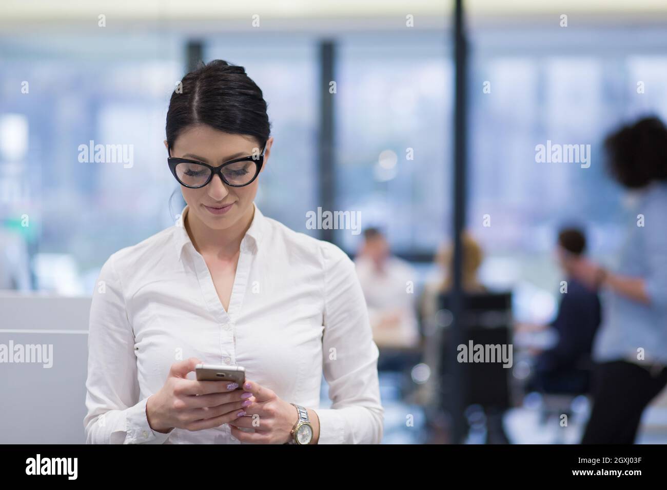 female manager using cell telephone in startup office interior Stock ...