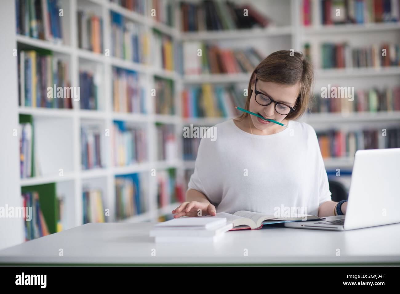 female student study in school library, using laptop and searching for ...
