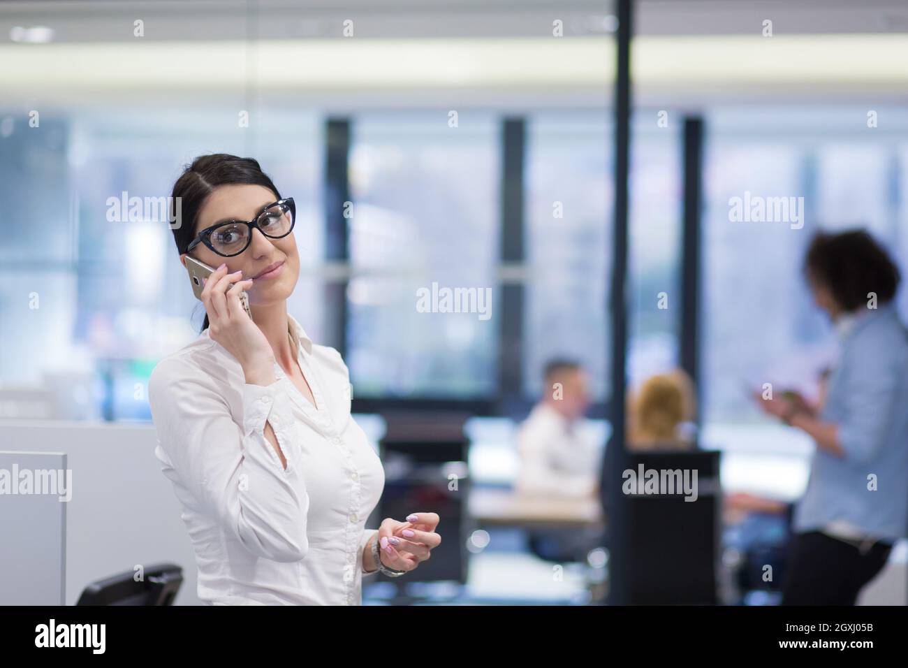 female manager using cell telephone in startup office interior Stock ...