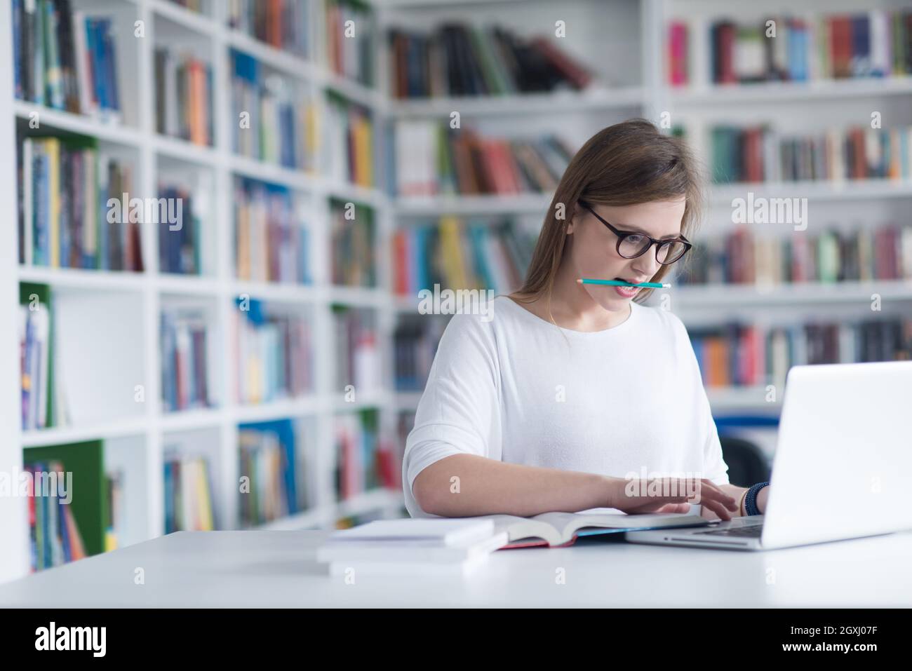 female student study in school library, using laptop and searching for ...