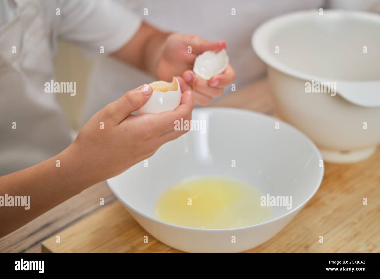 Boy hands separating the egg white from the yolk for the pie Stock Photo - Alamy