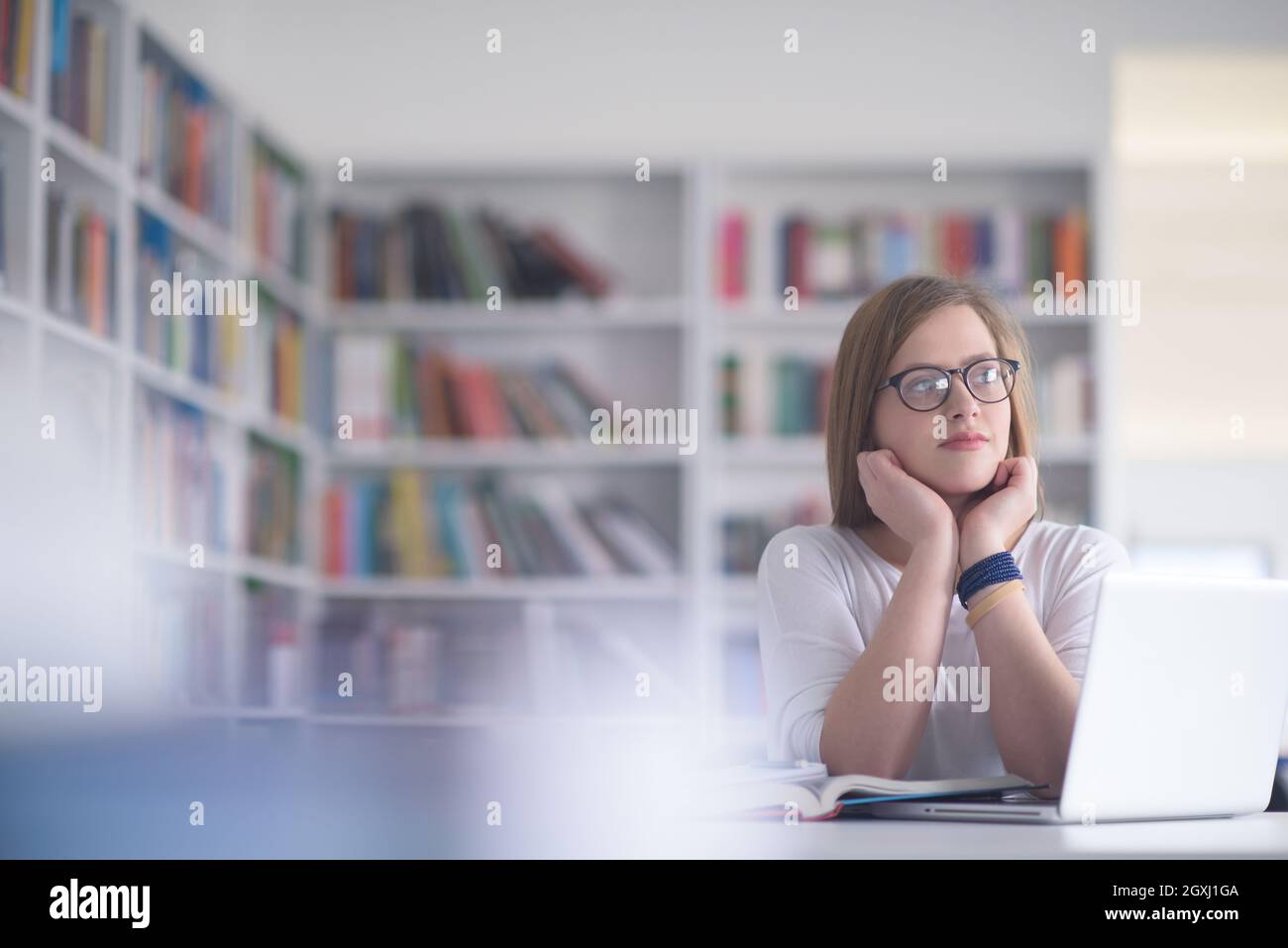 female student study in school library, using laptop and searching for ...